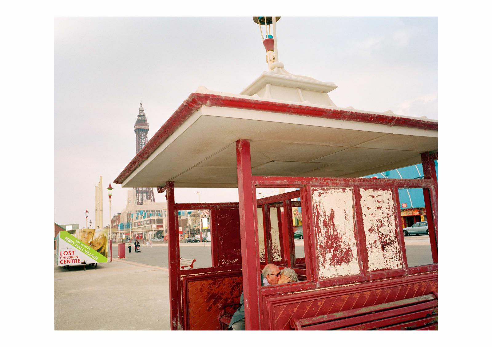 Peter Dench, An elderly couple kiss in a weather shelter on Blackpool ...
