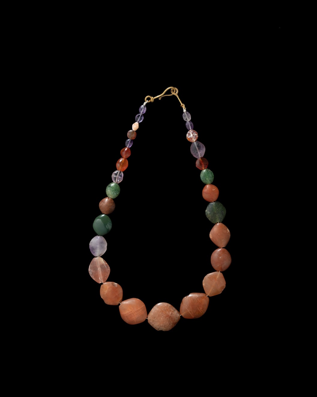 Egyptian, A necklace of Egyptian hardstone large lentoid beads, Middle ...