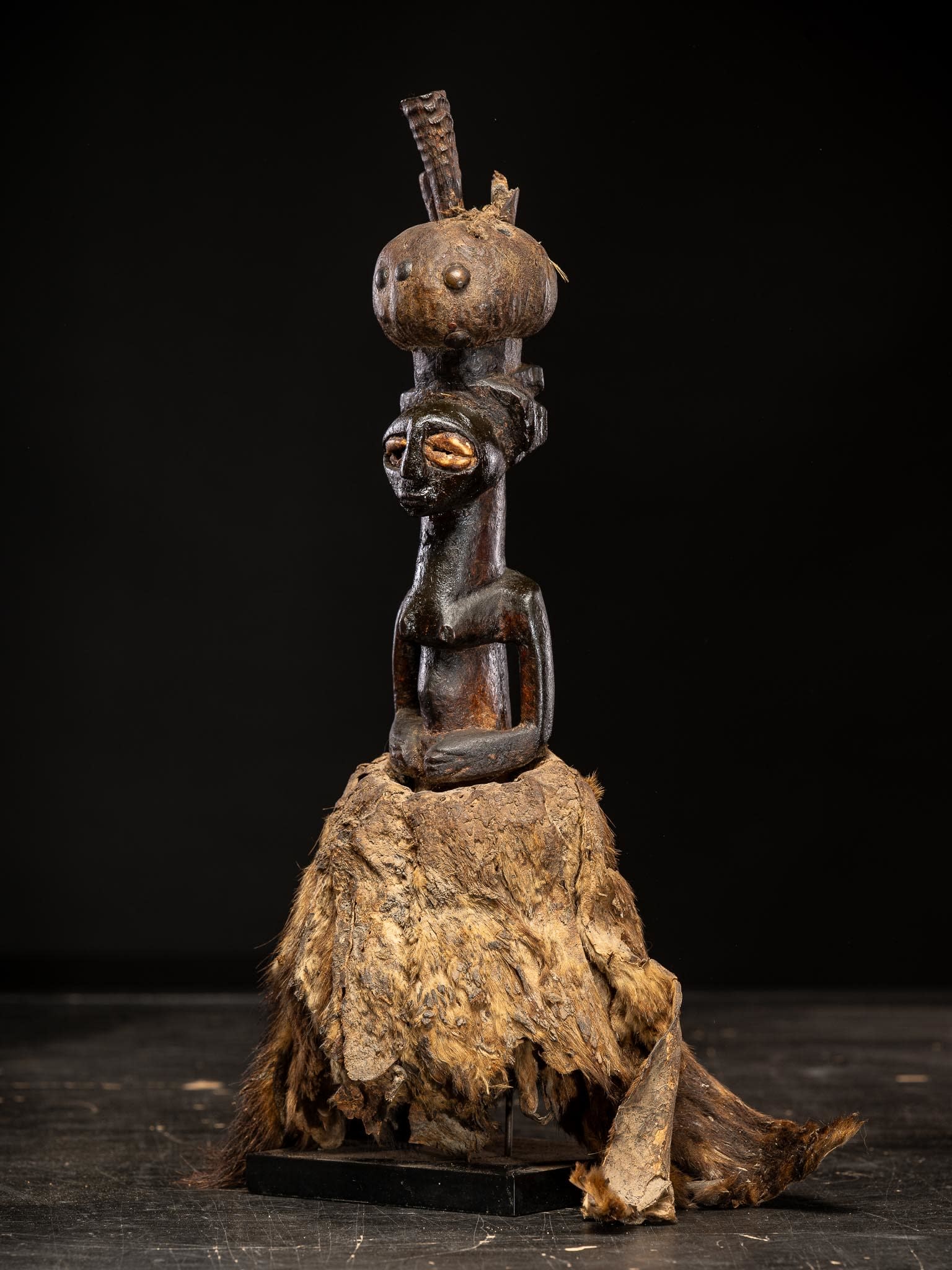 Power figure with cauris inlaid eyes topped with small antilope horns ...