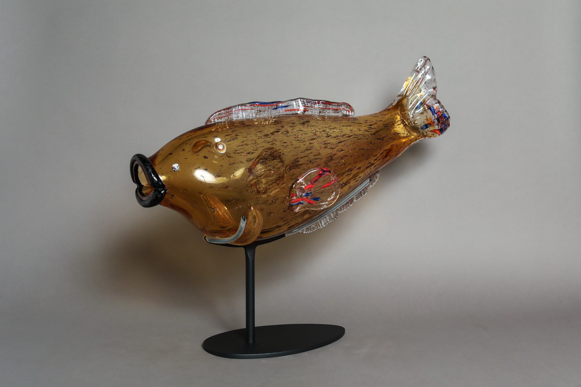Hugh Findletar, Fish 2 amber with copper dust-red and blue finz stripes ...